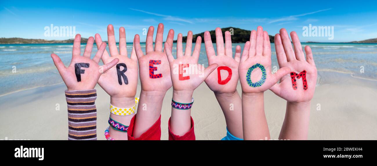 Children Hands Building Word Freedom, Ocean Background Stock Photo - Alamy