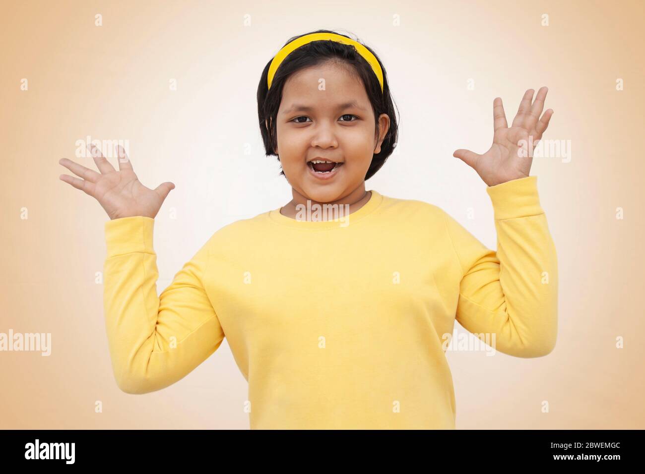 Portrait Of Girl With Arms Raised While Standing Against Color ...