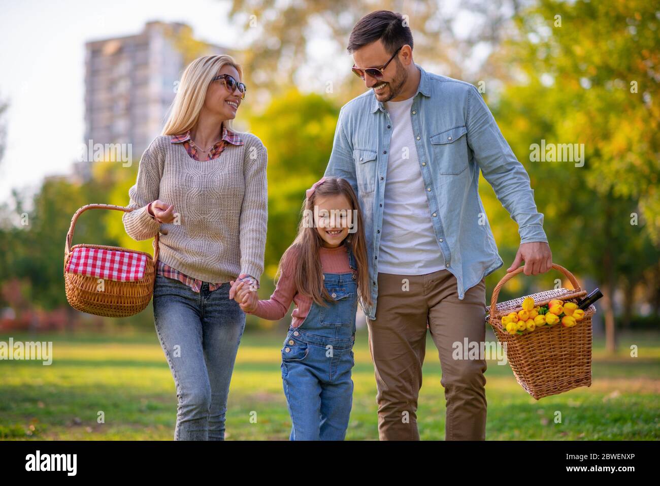Happy family having picnic in park.Young happy family of three having ...