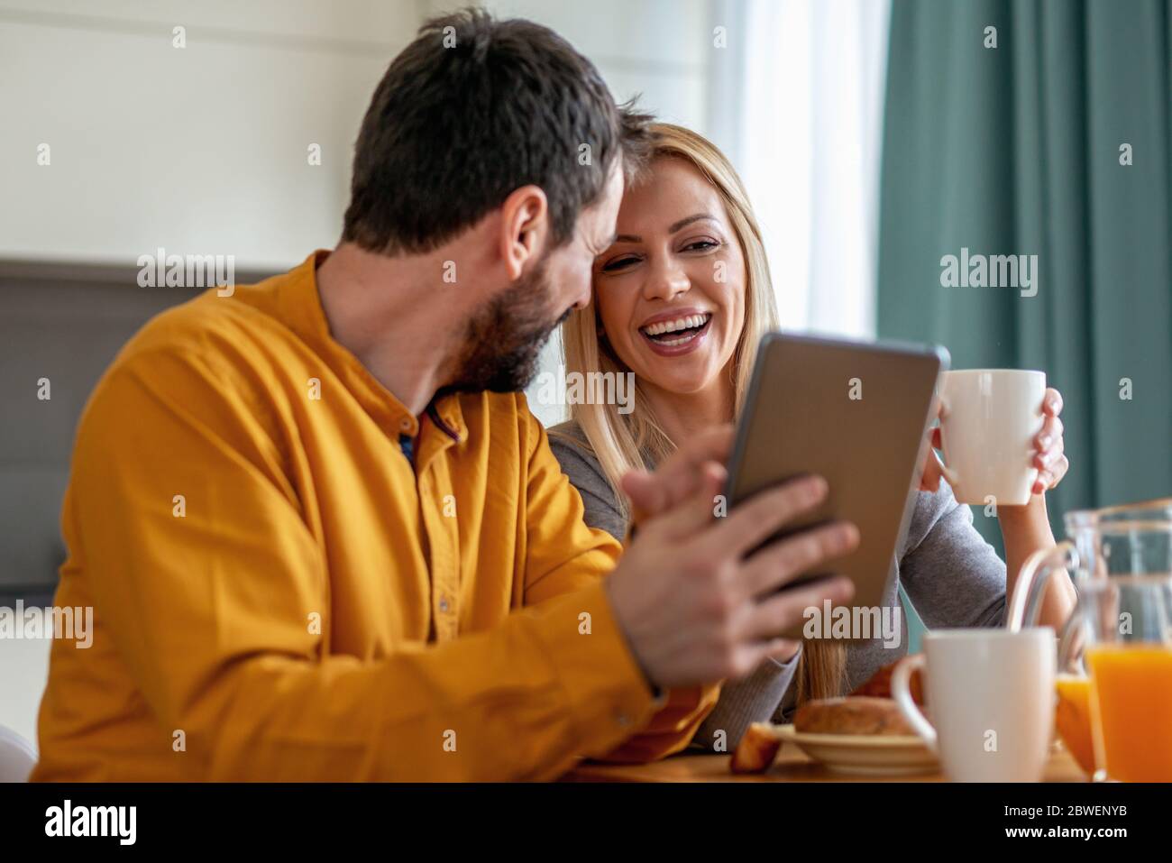 Couple in love eating breakfast together in morning at kitchen.Happy ...