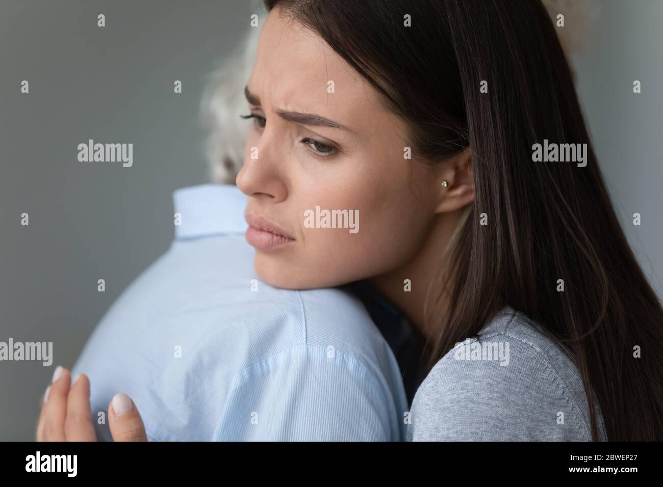 Adult daughter cuddles elderly mother showing care express empathy ...