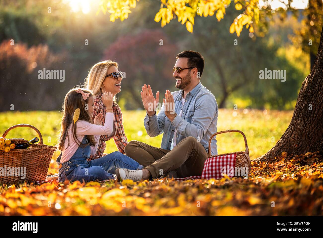 Happy family having picnic in park.Young happy family of three having ...