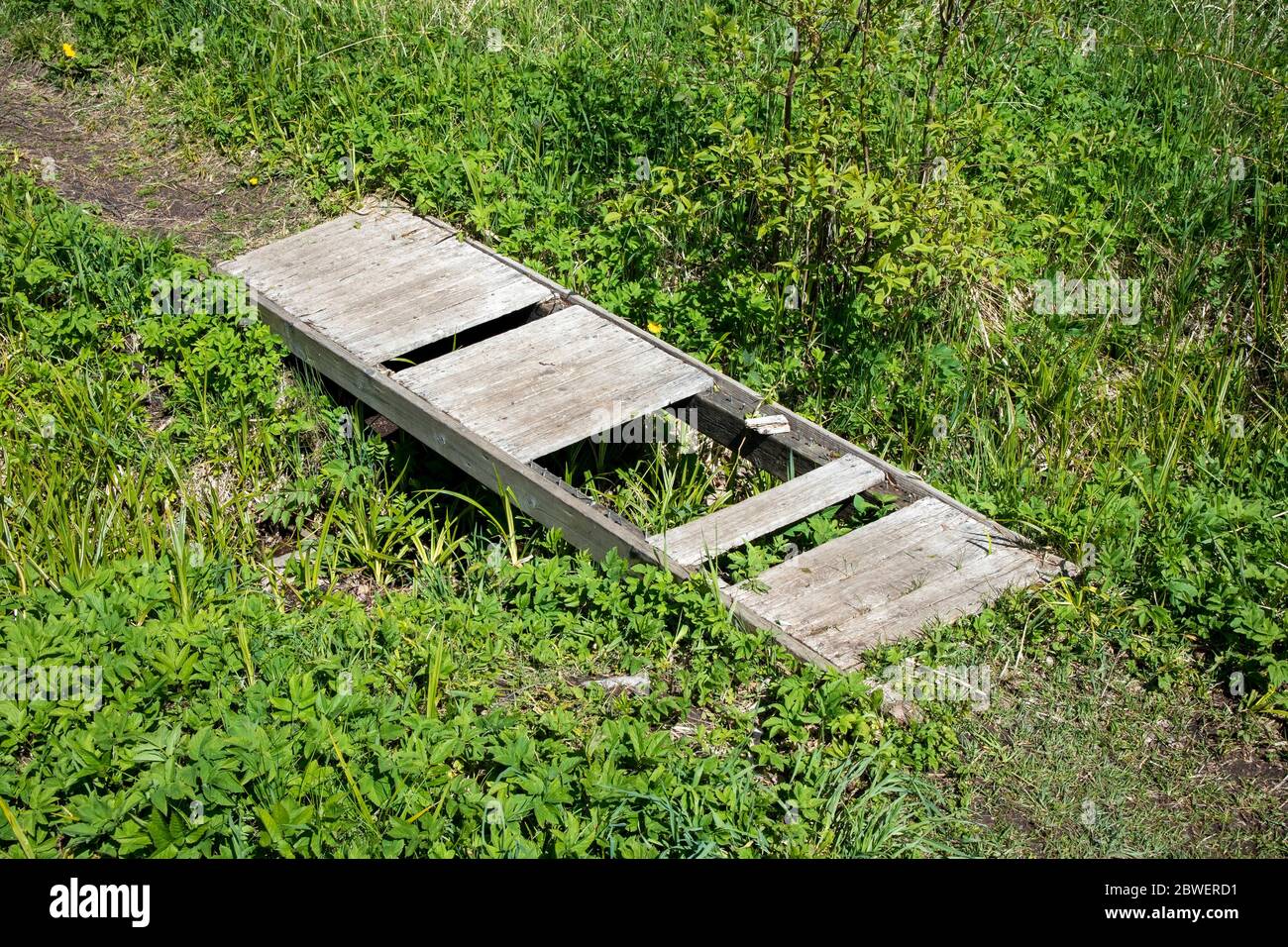 little wooden bridge with missing planks Stock Photo - Alamy