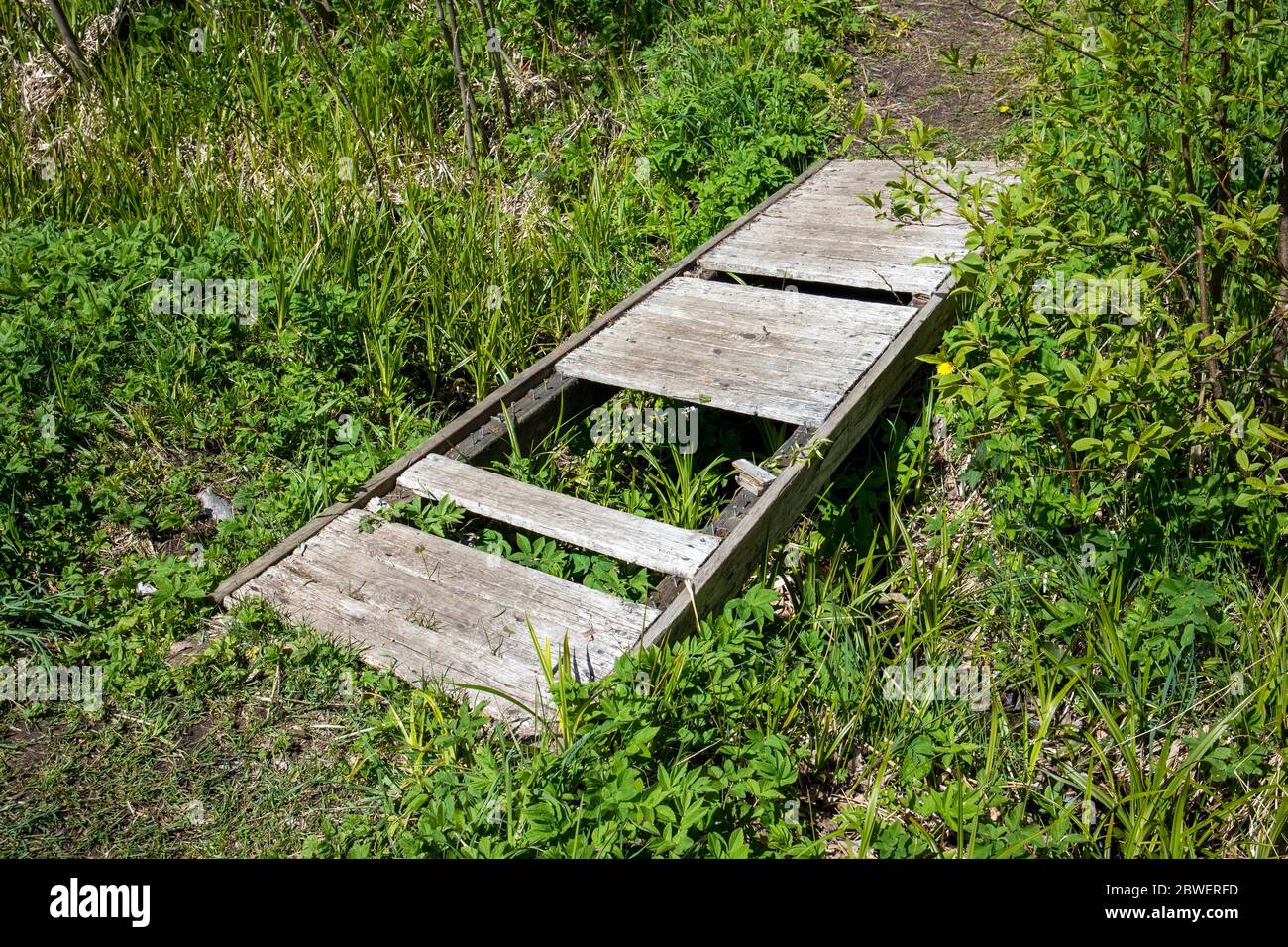 little wooden bridge with missing planks Stock Photo - Alamy