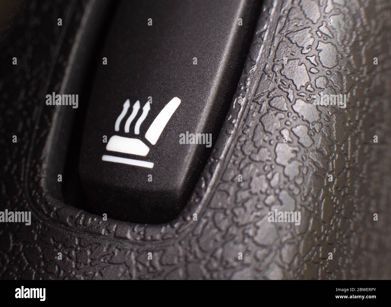 Seat heating power button, closeup. Modern switch in the car ...