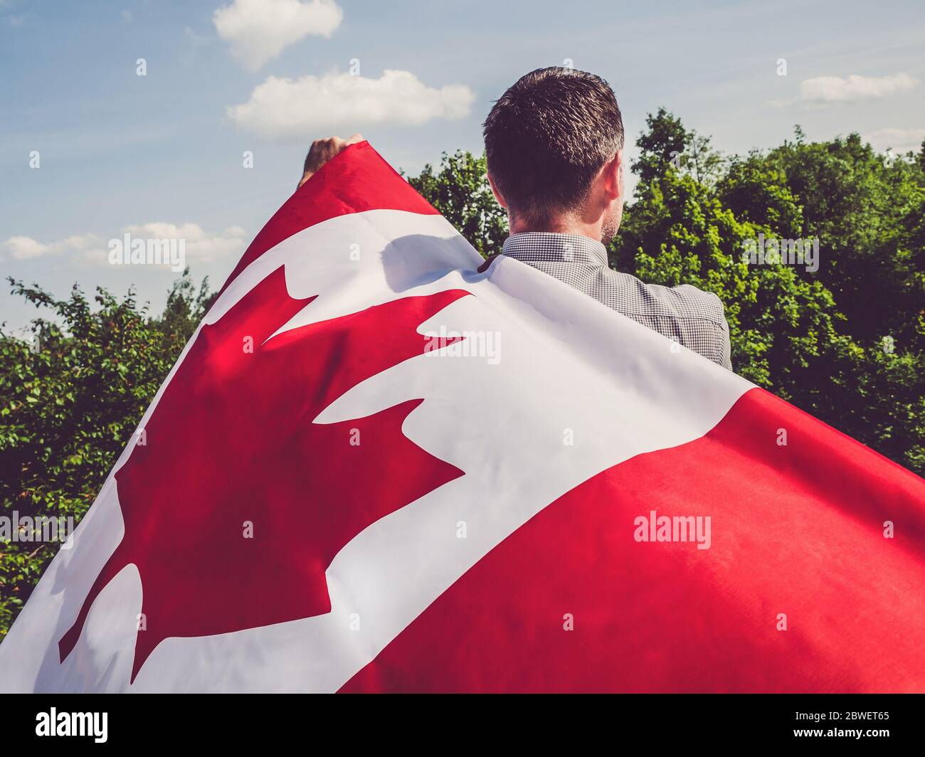 Attractive man holding Canadian Flag. National holiday Stock Photo - Alamy