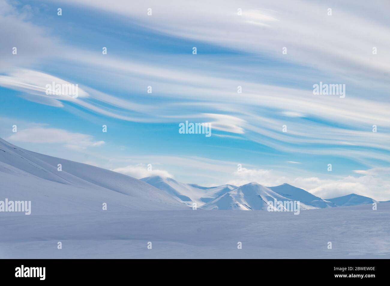 Unique arctic sky with snowy hills and special cloud formation Stock ...