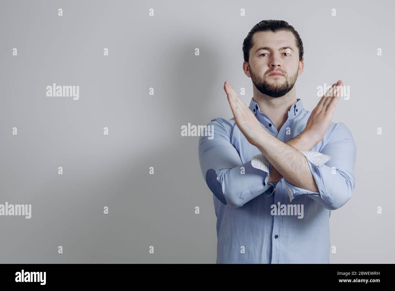 Man on a gray background. Shows hands stop. Stop racism. Stop virus ...