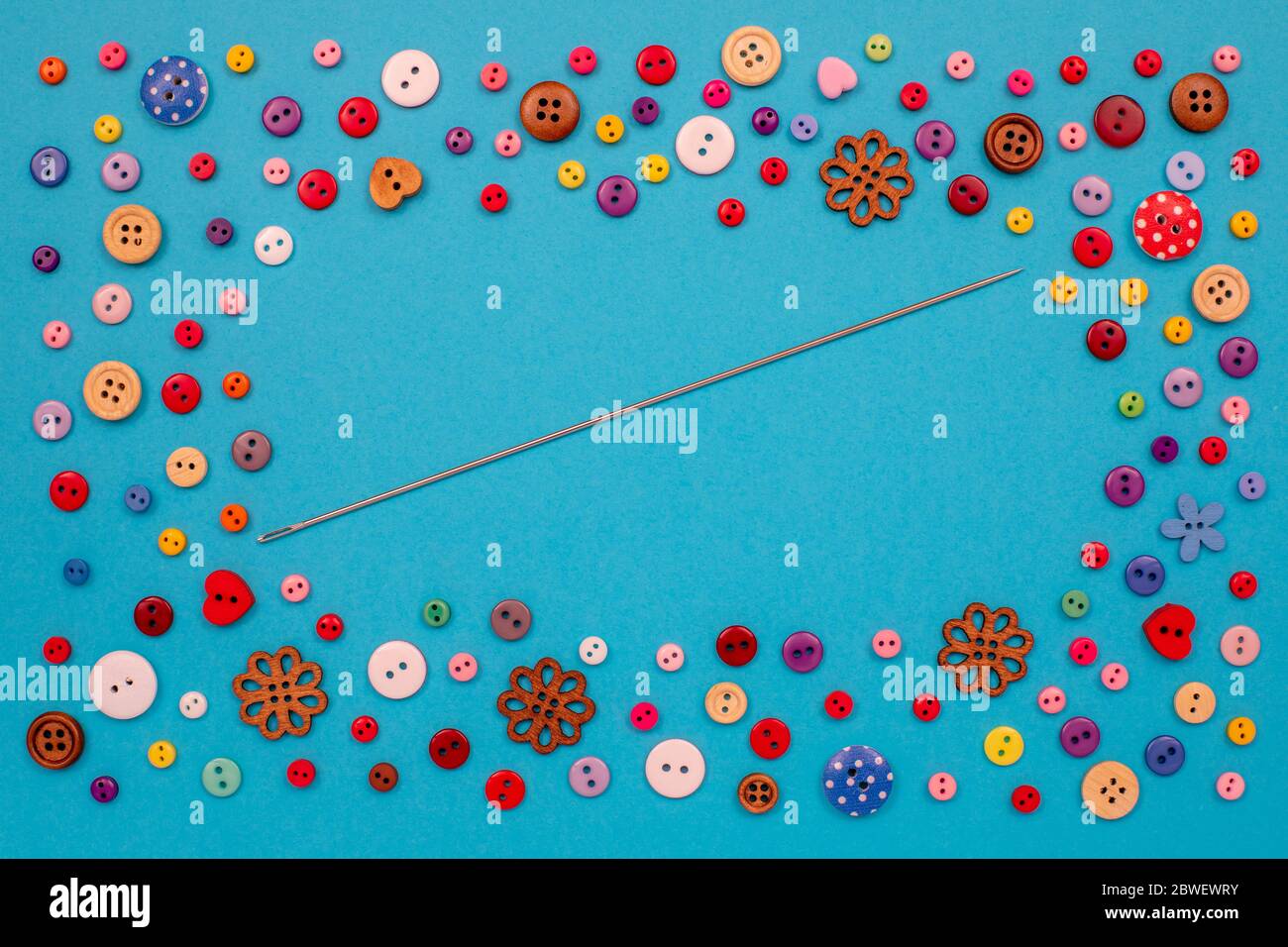Multi-colored buttons are scattered on the table, a needle. Accessories ...