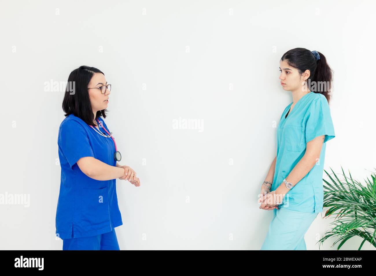 Female doctor and nurse talking with withe background wall Stock Photo ...