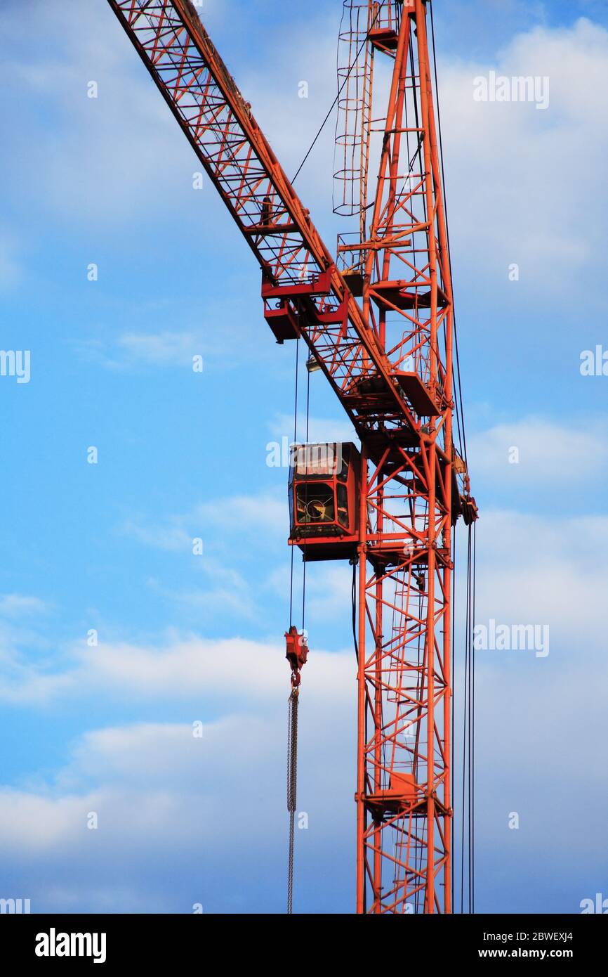Industrial theme. Red construction crane against blue sky Stock Photo ...