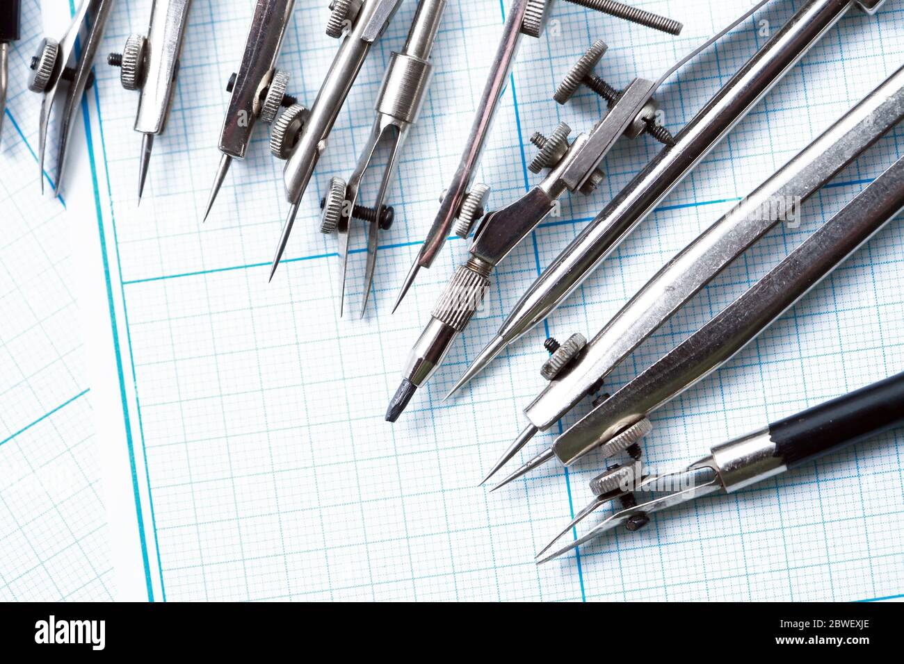 Set of old drawing tools on background with graph paper Stock Photo - Alamy