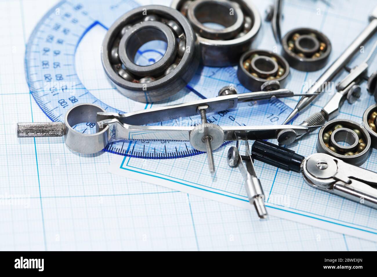 Set of old drawing tools on background with graph paper Stock Photo - Alamy