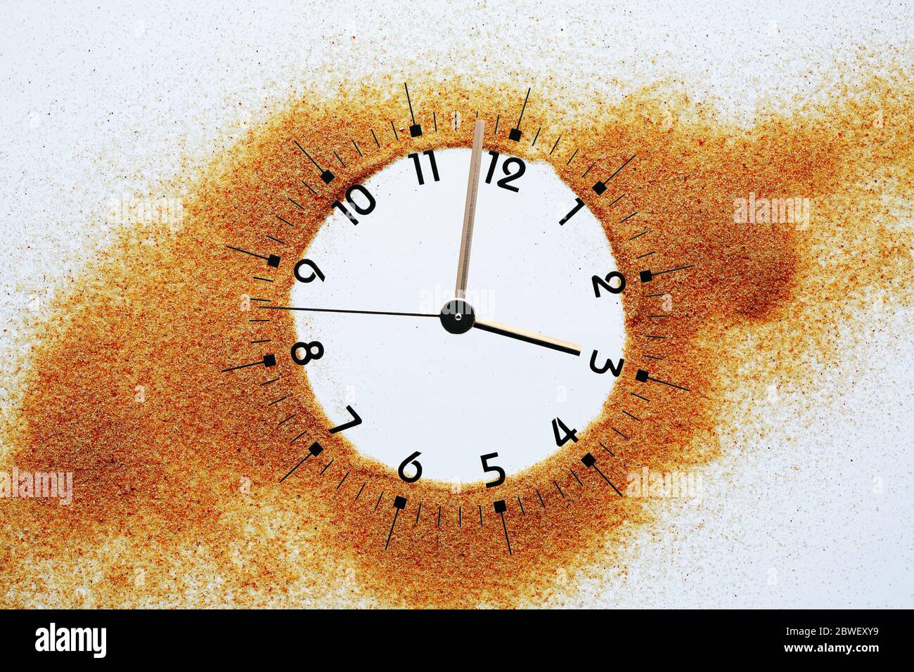 Abstract composition with clock dial inside sand flowing background ...