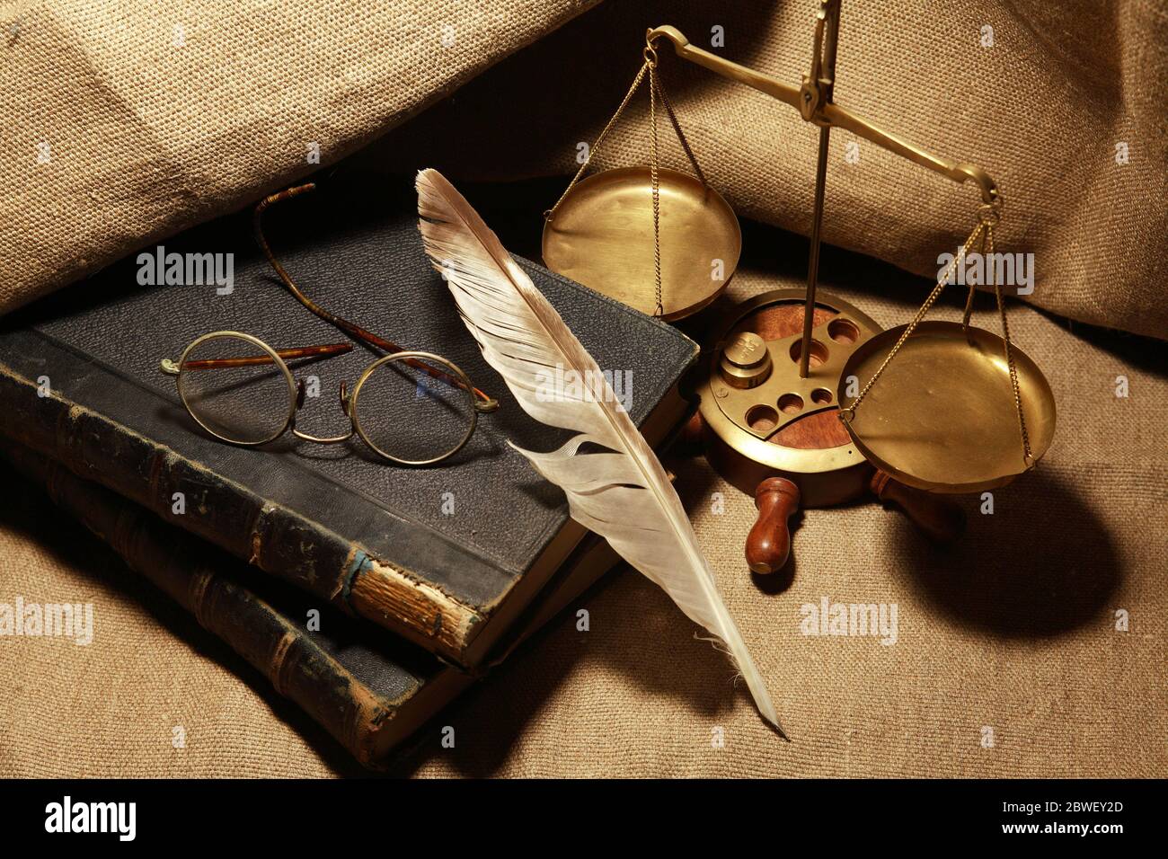 Vintage still life with old books and quill pen on canvas background ...