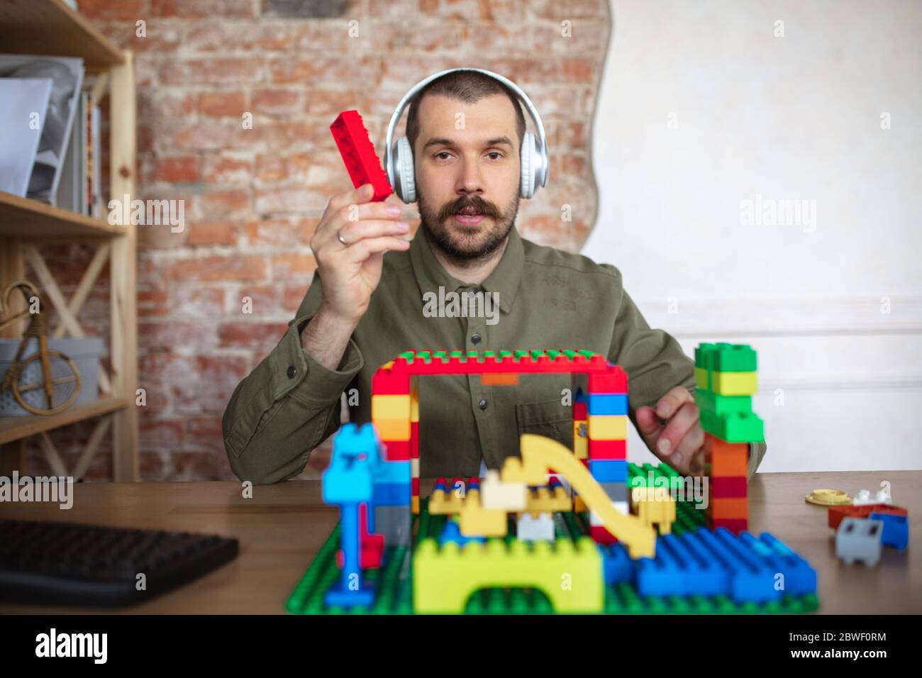 Man giving online lesson with constructor at home. Recording teacher's ...