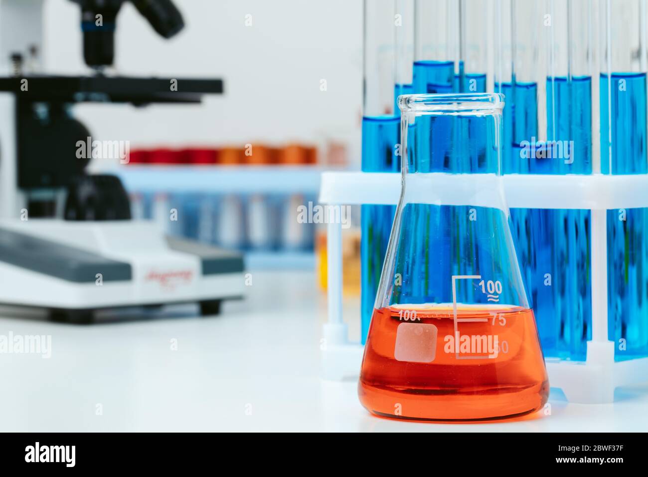 Microscope and test tubes on table in laboratory, close up Stock Photo ...