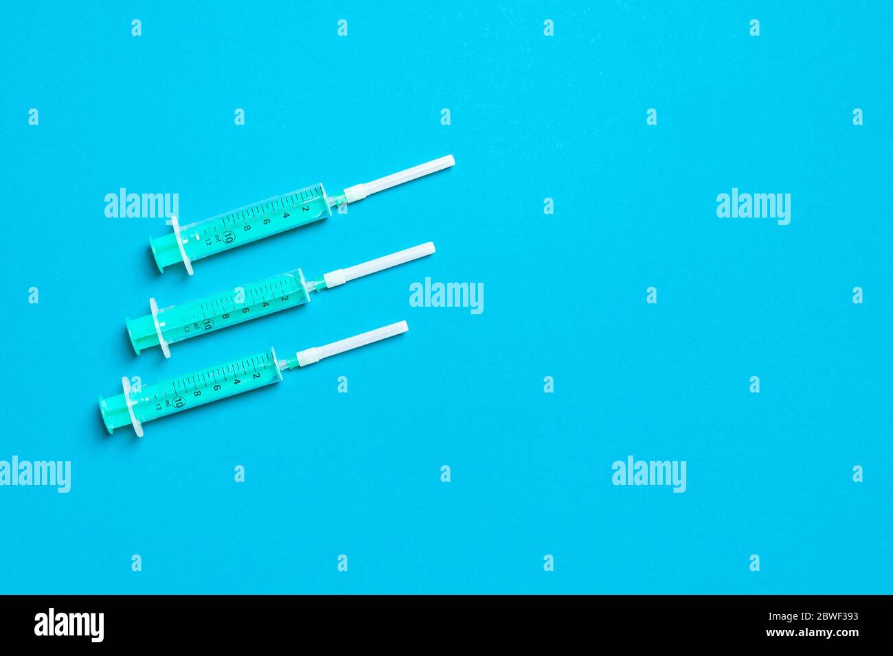 Top view of syringes in a row for medical injection on colorful ...