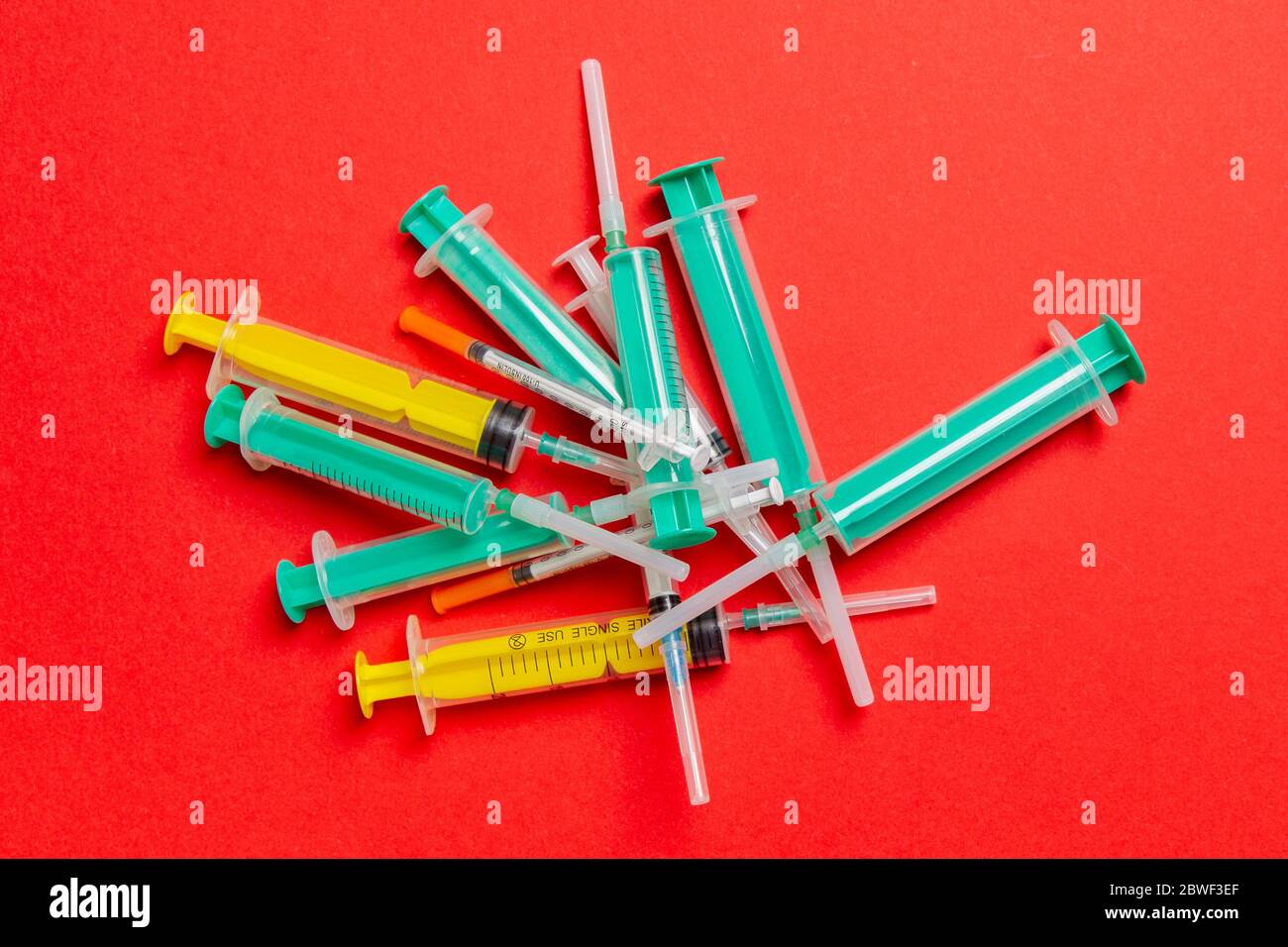 Top view of a pile of medical syringes and insulin syringes with ...