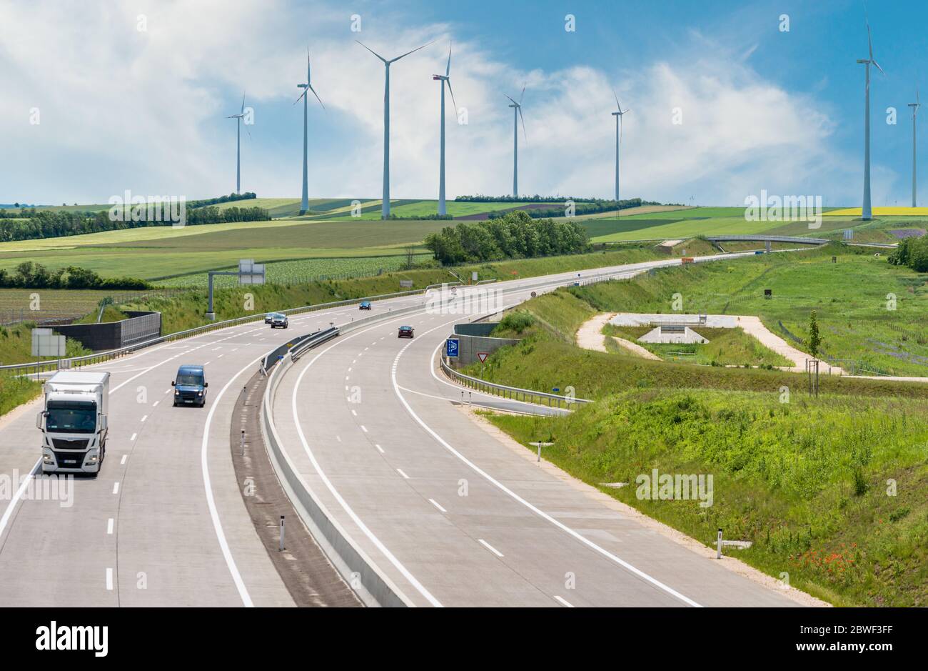 Cars on highway, wind turbines on background Stock Photo - Alamy