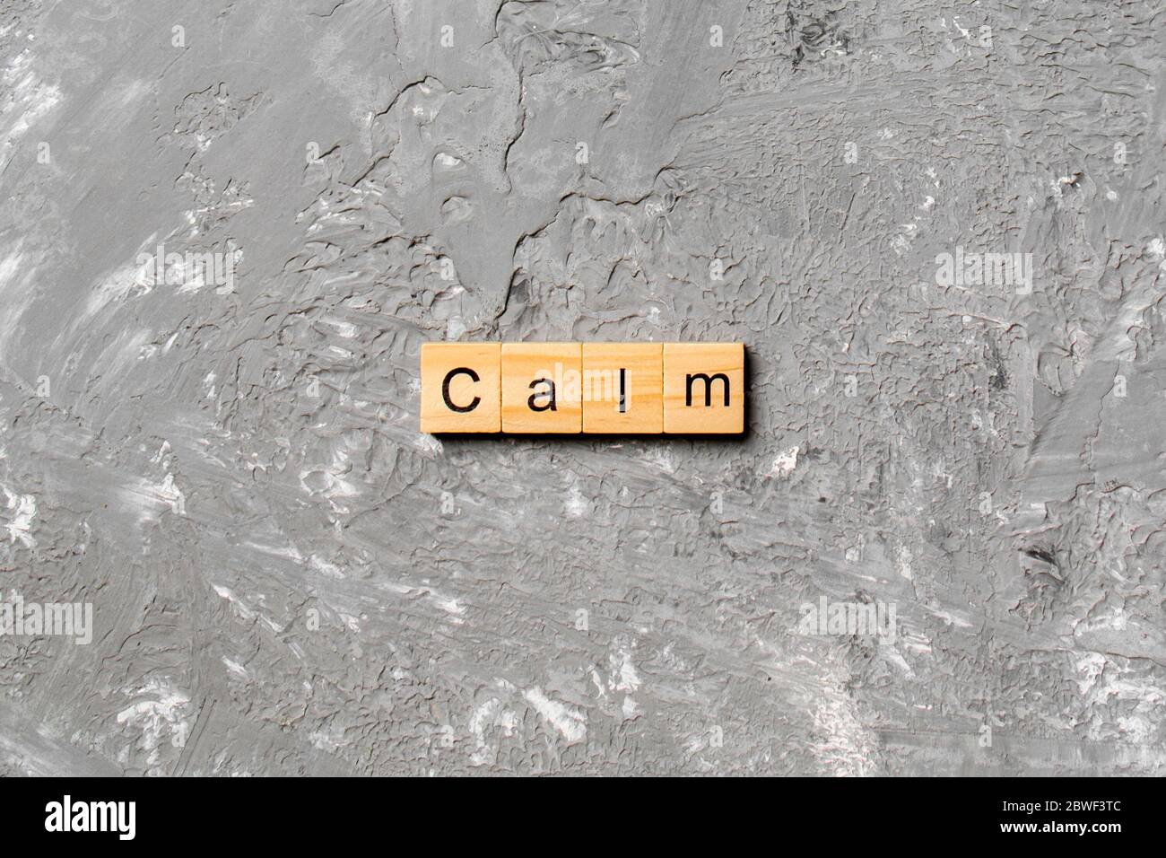 calm word written on wood block. calm text on cement table for your ...
