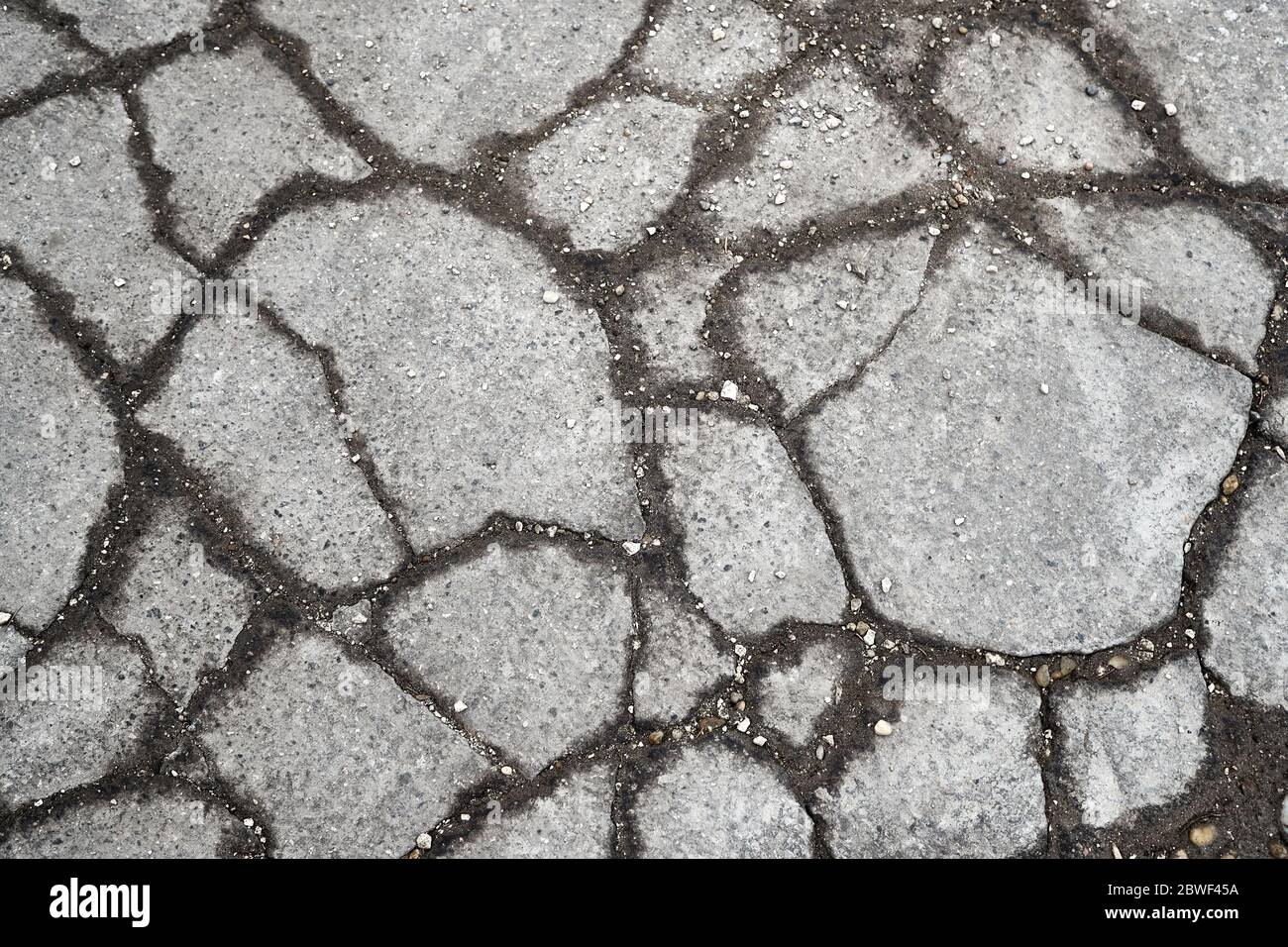 Stone pavement broken near construction Stock Photo - Alamy