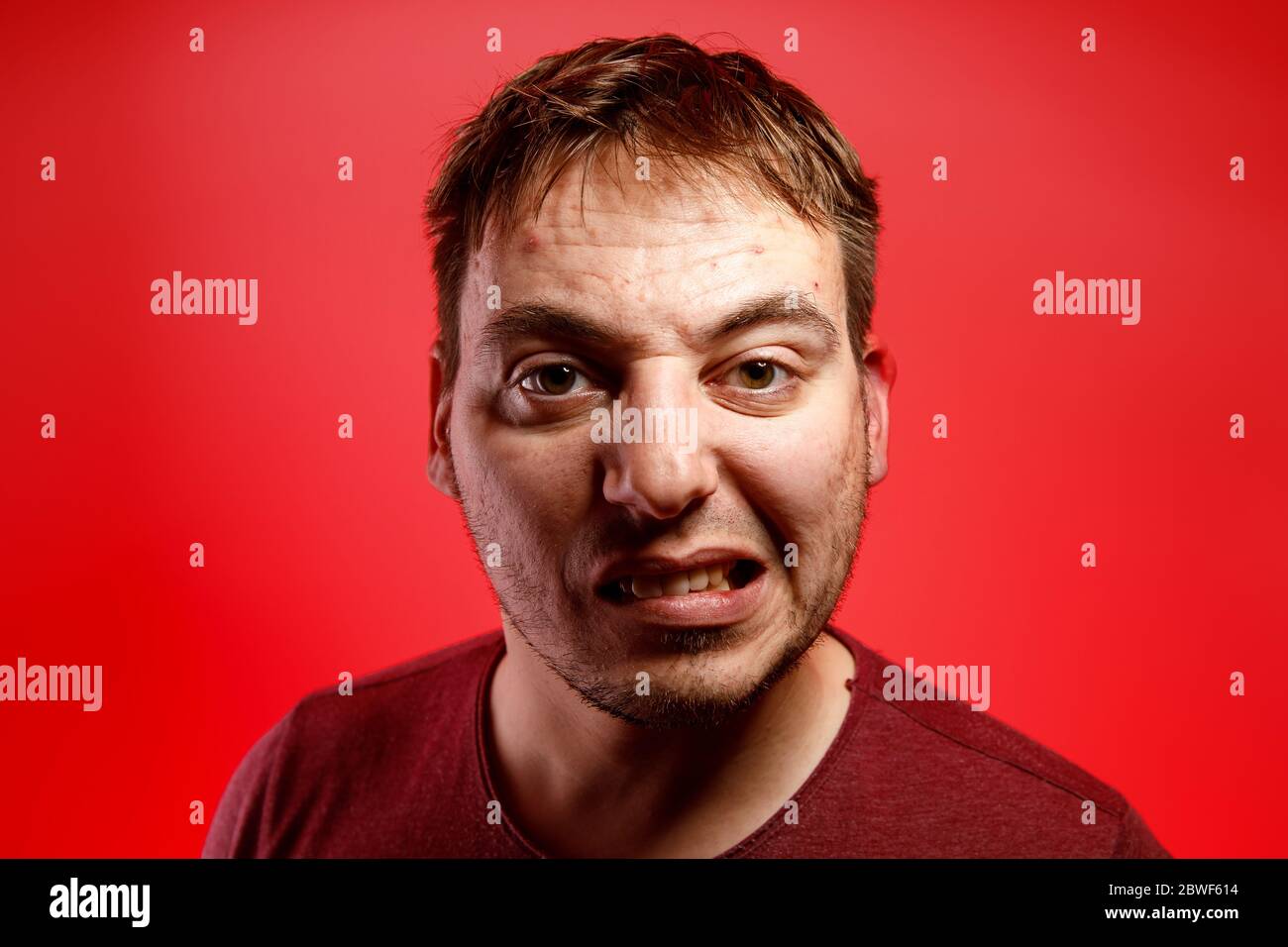 Angry man on a red background Stock Photo - Alamy