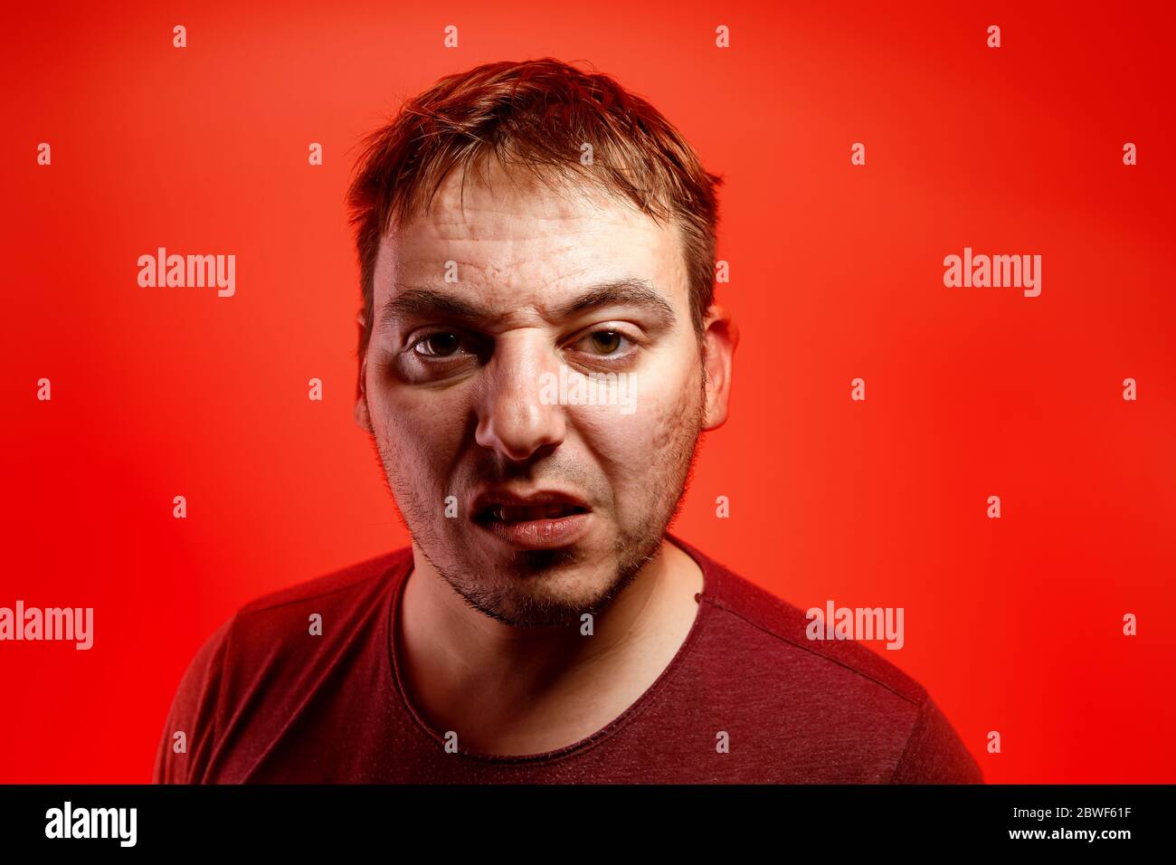 Angry man on a red background Stock Photo - Alamy