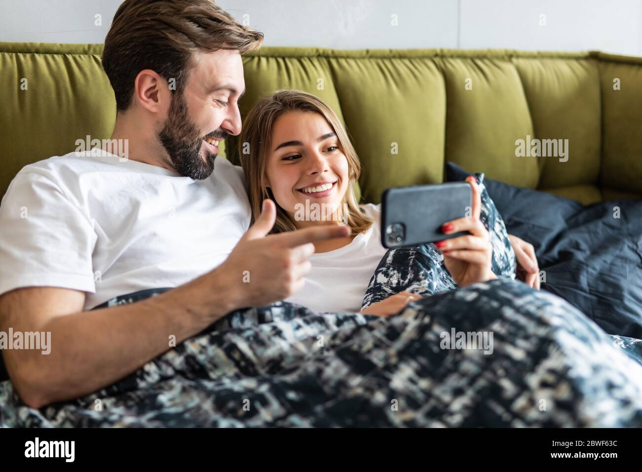 Couple in bed using mobile phones hi-res stock photography and images ...