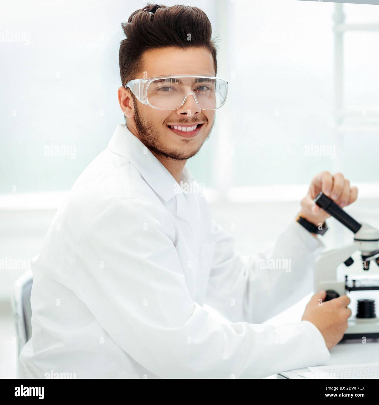 modern scientist sitting at his Desk in the laboratory Stock Photo - Alamy