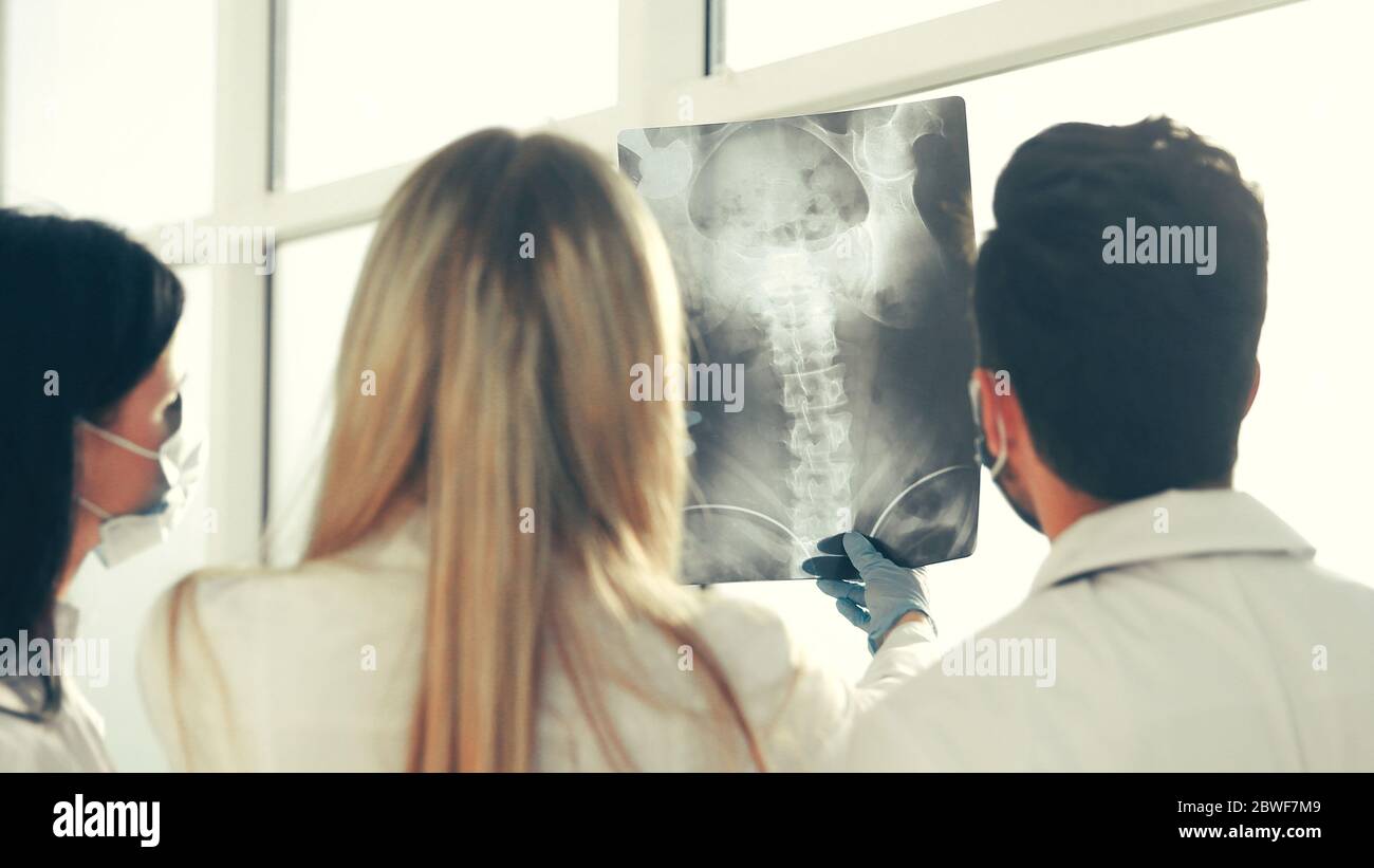 rear view. a group of surgeons discussing x-ray Stock Photo - Alamy