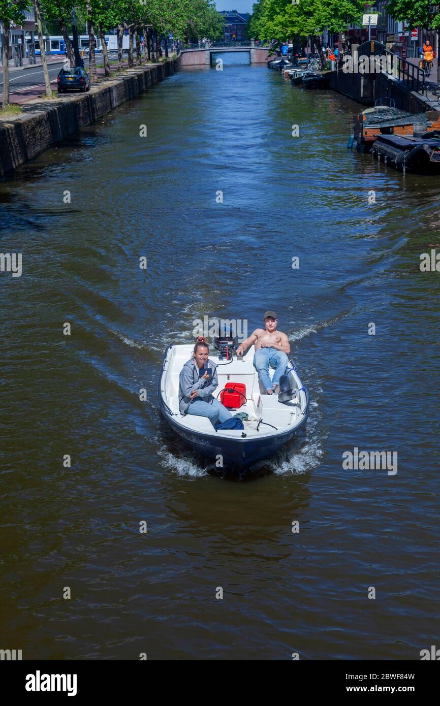 Relaxing and crossing the canal with small boat,Amsterdam,Netherlands ...