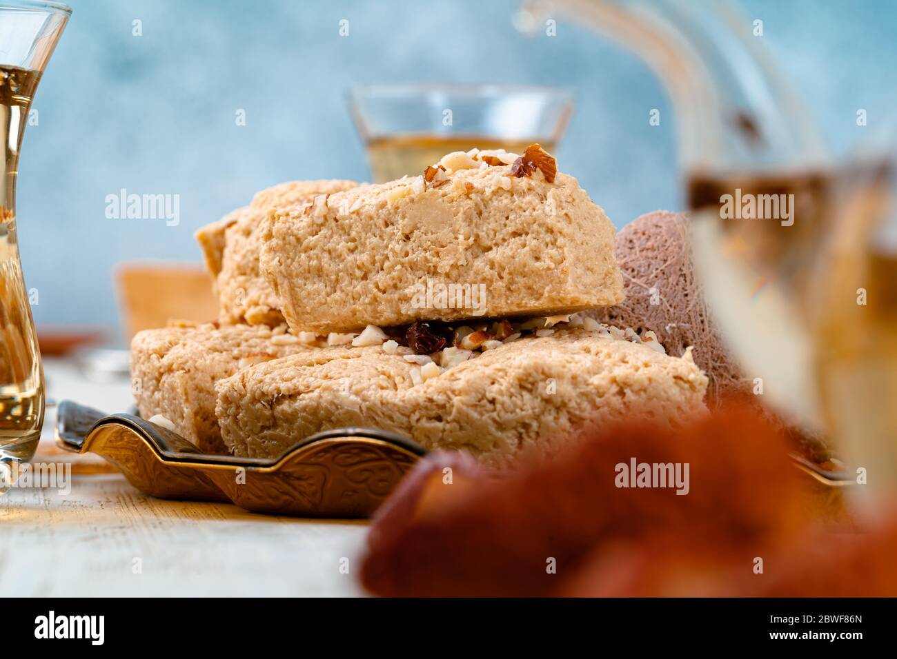 Turkish halva with tea in a glass cup close up Stock Photo - Alamy