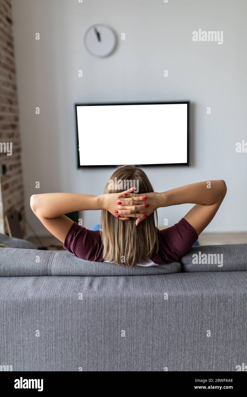 Back view of woman sitting watching television program at home Stock ...