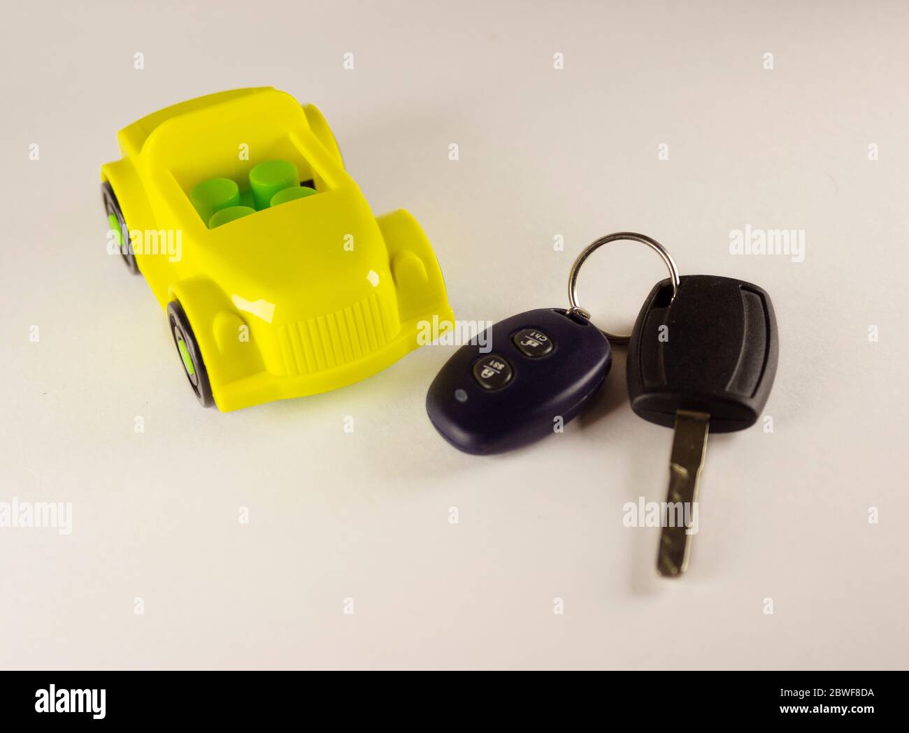Car Key, Yellow Toy Car On White background. Toy car with a keys on ...