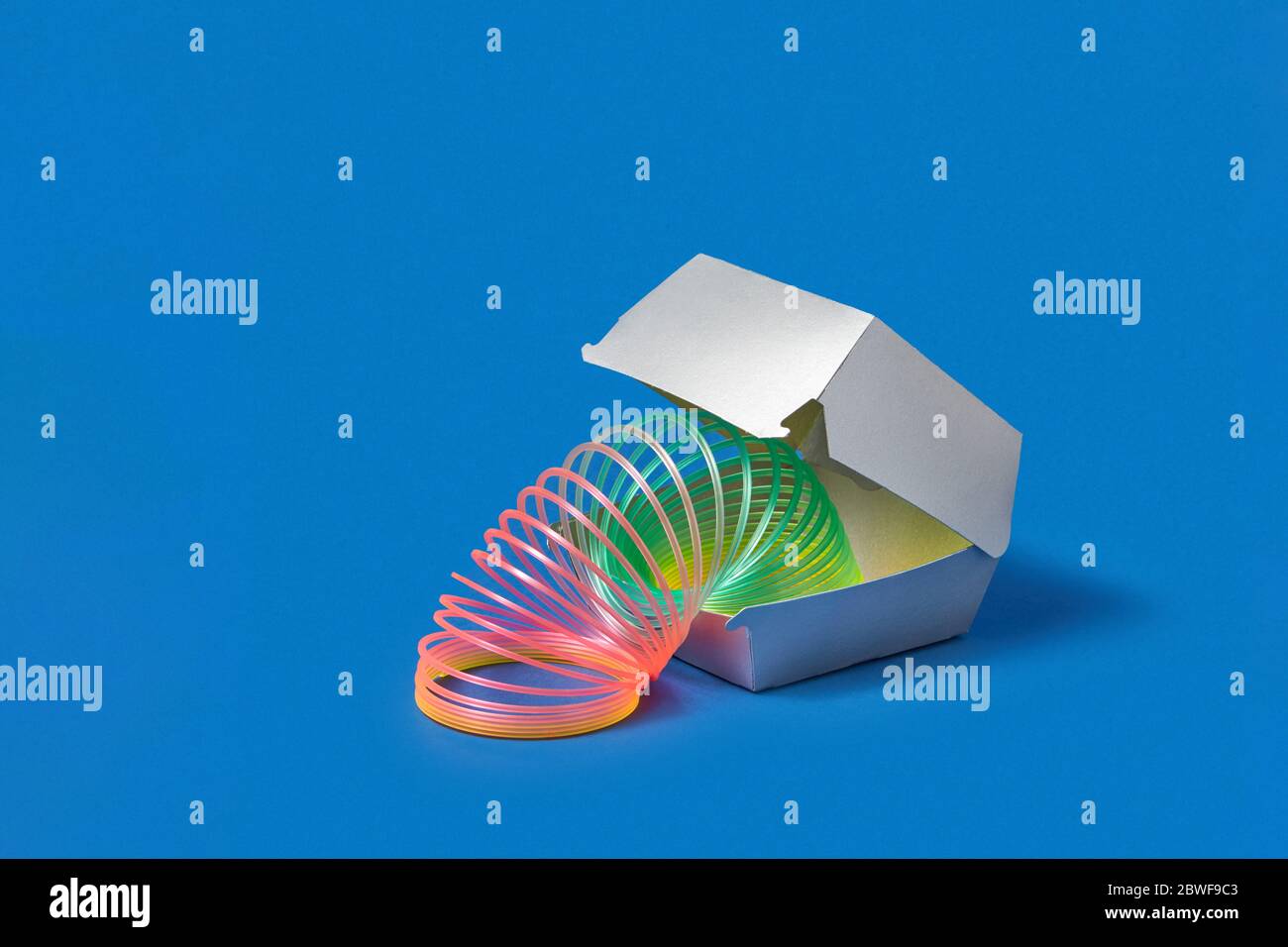 Flexible rainbow spring in a silver food container Stock Photo - Alamy