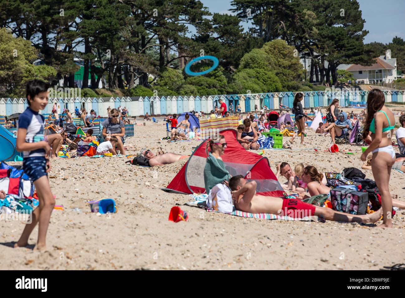 Crowds enjoy the hot weather at Avon beach, Mudeford as the coronavirus ...
