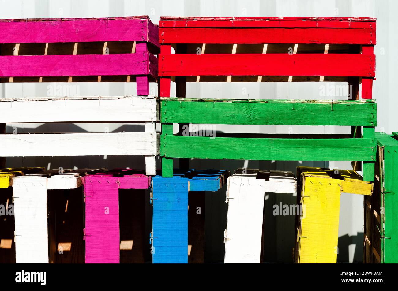 Stack of empty fruit crates painted with different colors Stock Photo ...