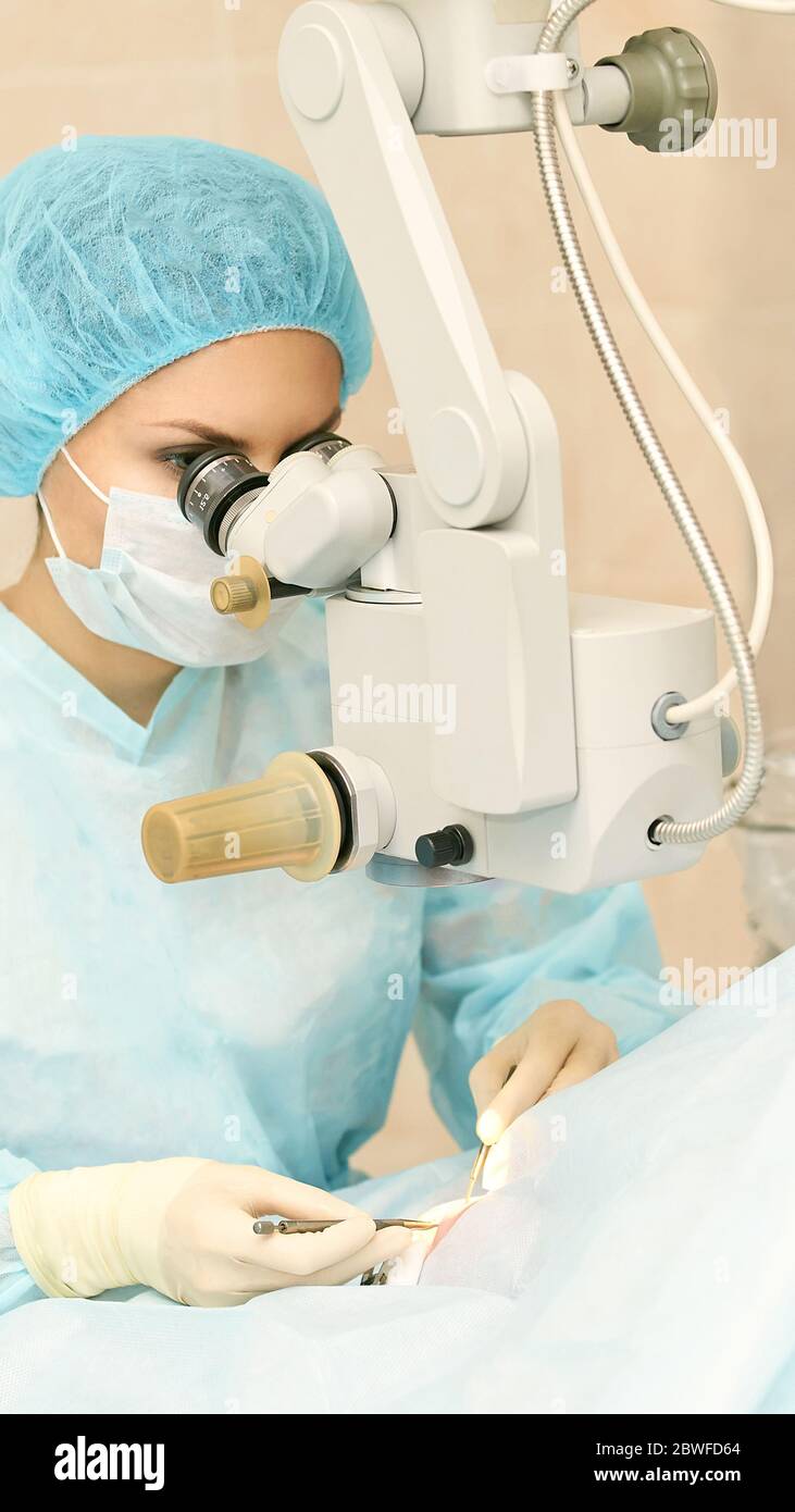 Ophthalmology laser microscope operation. Doctor in clinic. Patient eye ...