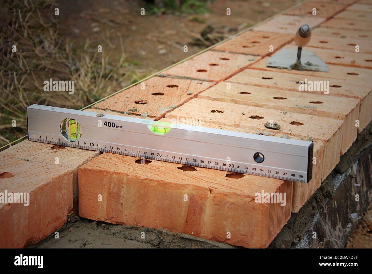 Row of Red Bricks on a Wall. Selective focus. Red bricks on top of a ...