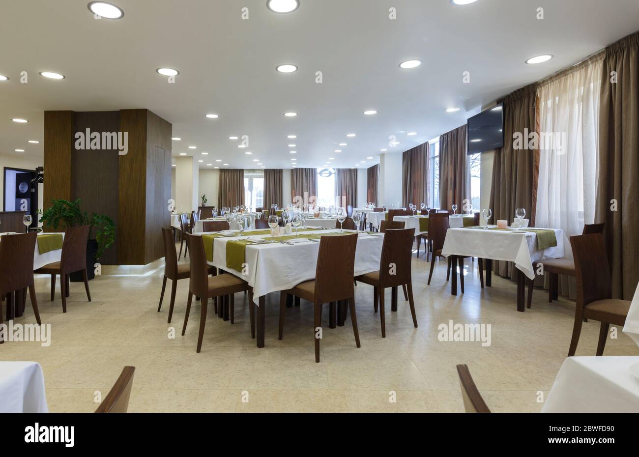 Tables in hotel restaurant with wooden chairs Stock Photo - Alamy