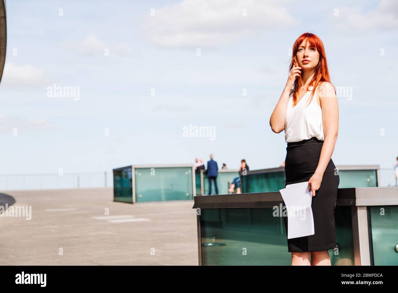 Young redhead business woman in formal outside Stock Photo - Alamy