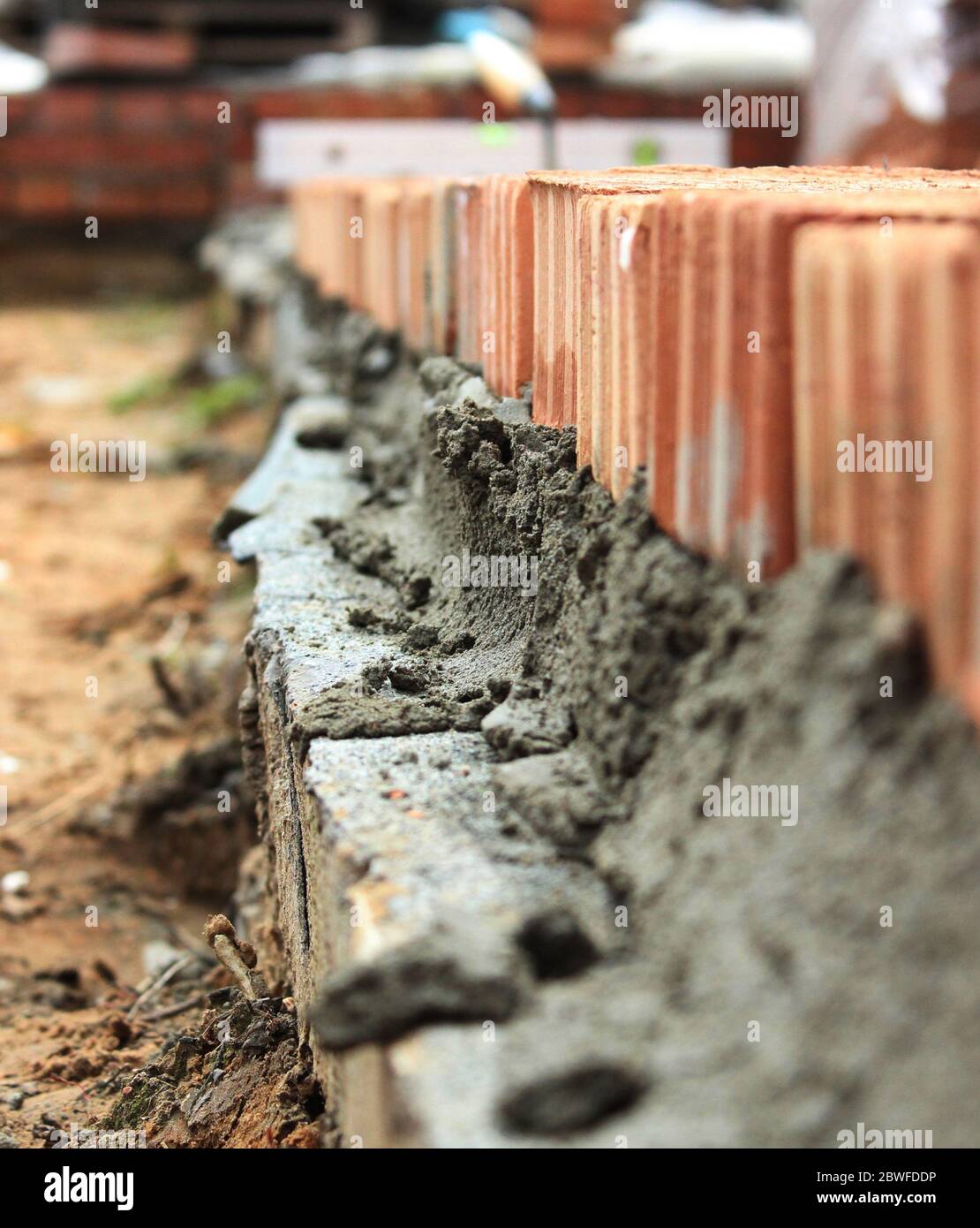 Row of Red Bricks on a Wall. Selective focus. Red bricks on top of a ...
