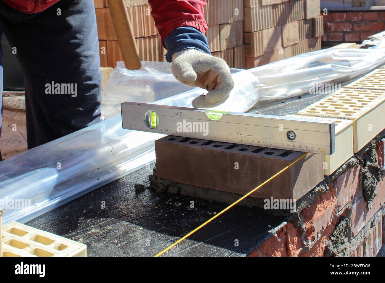 Bricklayers hands with in masonry trowel bricklaying new house wall on ...