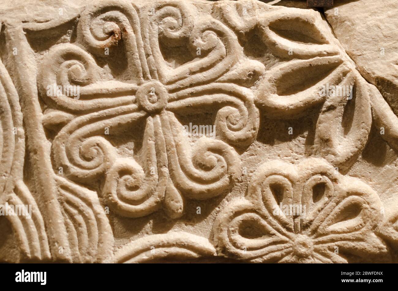 Romanesque decorations carved in the stone wall of an ancient medieval ...