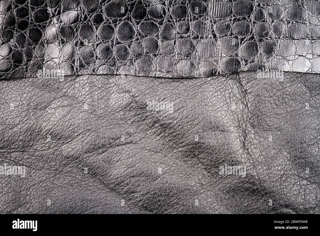 Black leather and fake artificial alligator skin textures background ...
