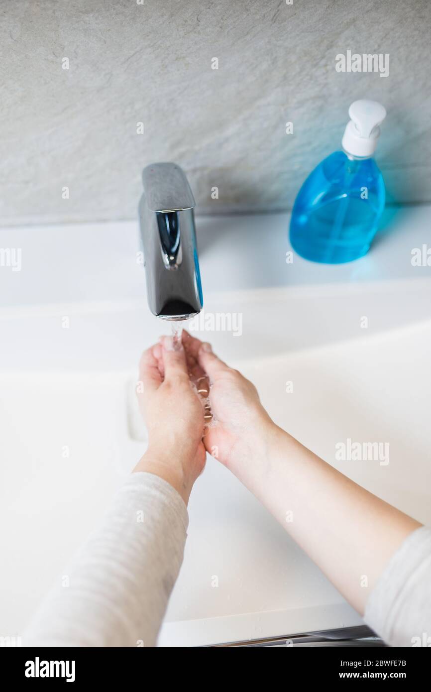 Washing hands under the water tap or faucet without soap. Hygiene ...