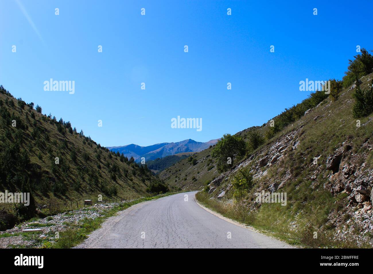 The road to the mountains. Mountains in the background. Between two ...