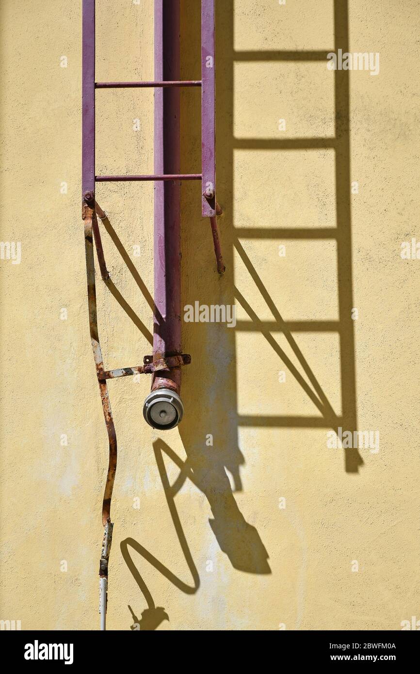 Firefighter ladder and pipeline on the building Stock Photo - Alamy