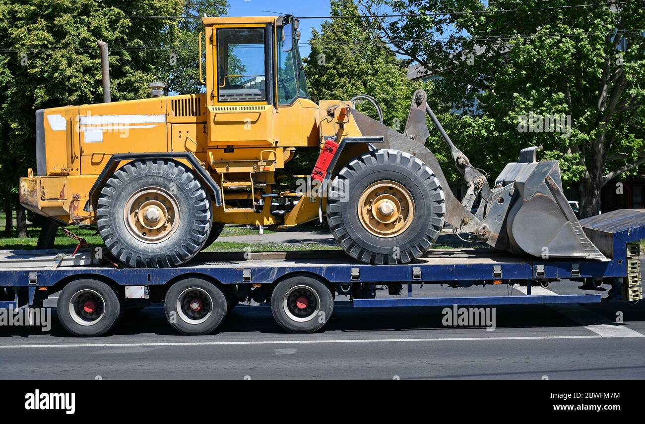 Excavator transported on a trailer Stock Photo - Alamy